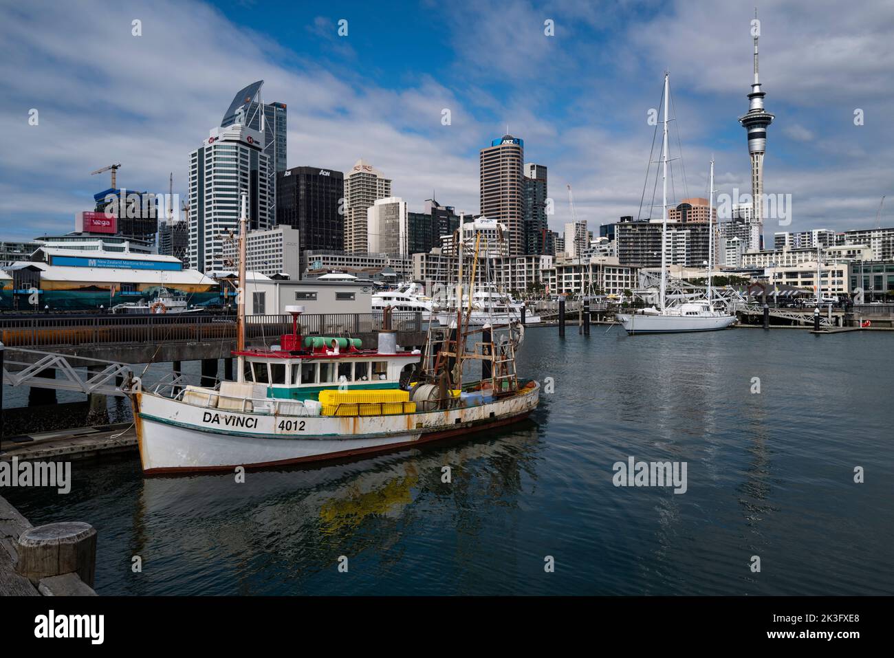 Auckland harbour on a spring day with fishing boats in port and the Sky ...