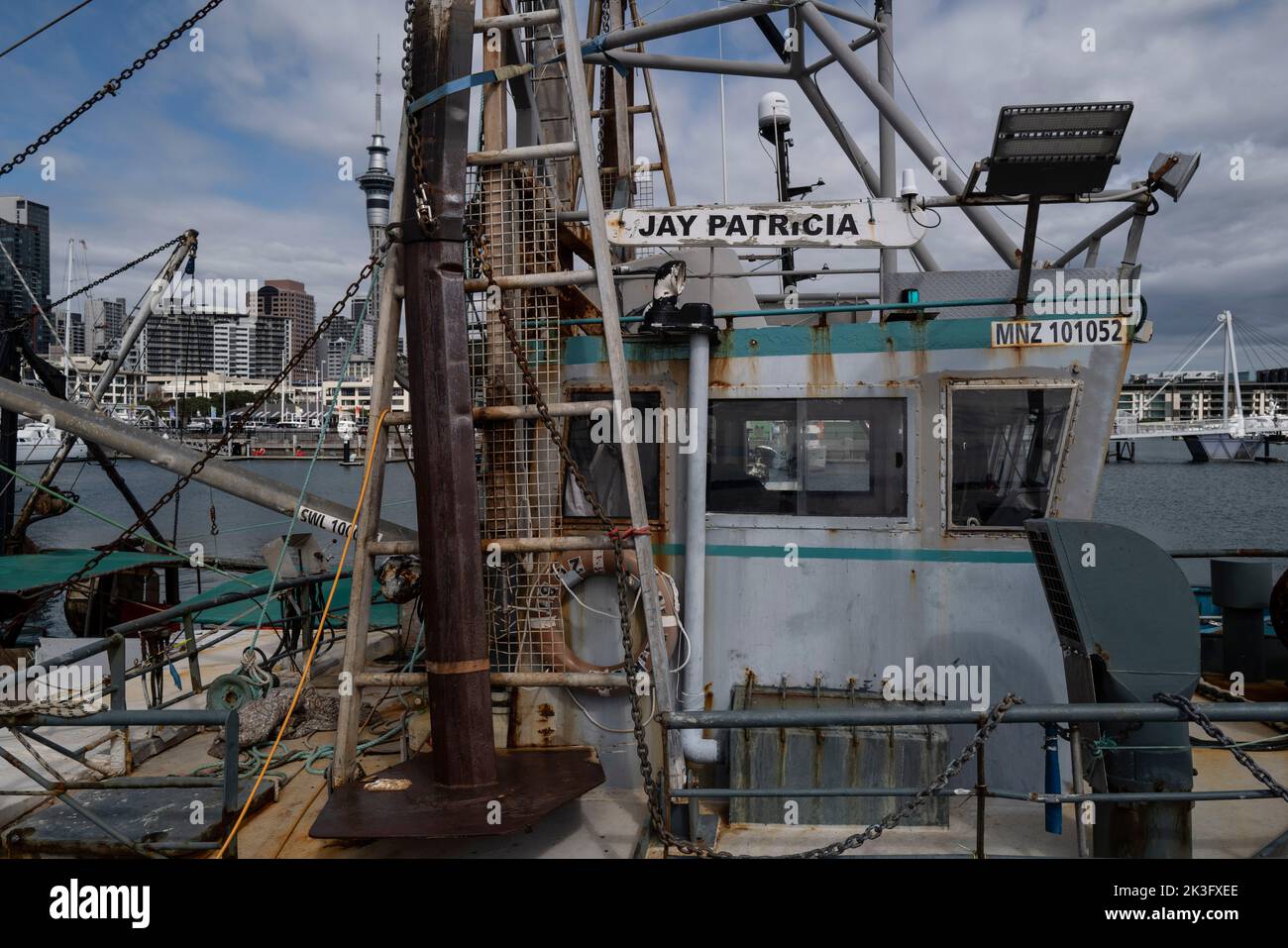 Auckland harbour on a spring day with fishing boats in port and the Sky ...