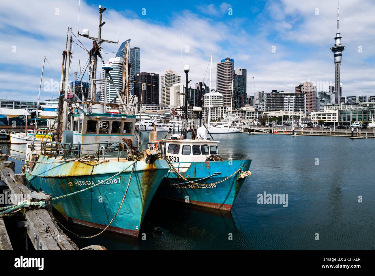 Auckland harbour on a spring day with fishing boats in port and the Sky ...