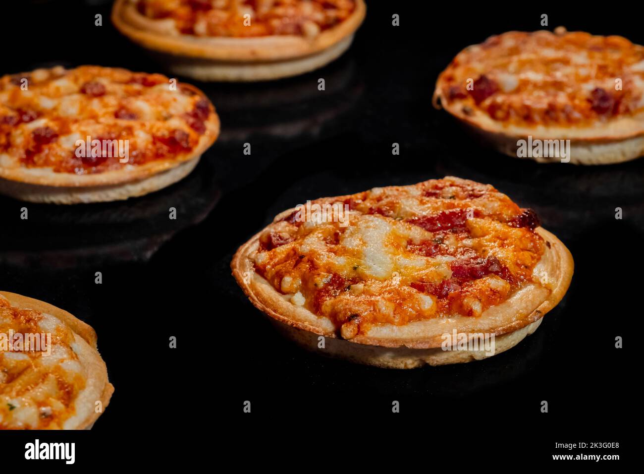 Baked homemade mini pizzas in electric oven at home Stock Photo - Alamy