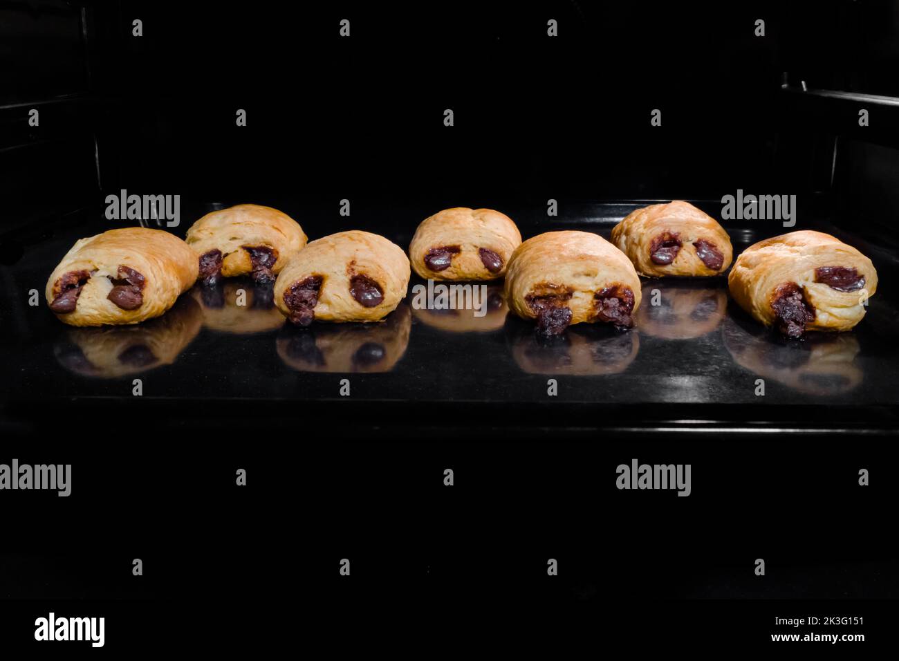 Seven baked mini homemade buns with chocolate filling - front view ...