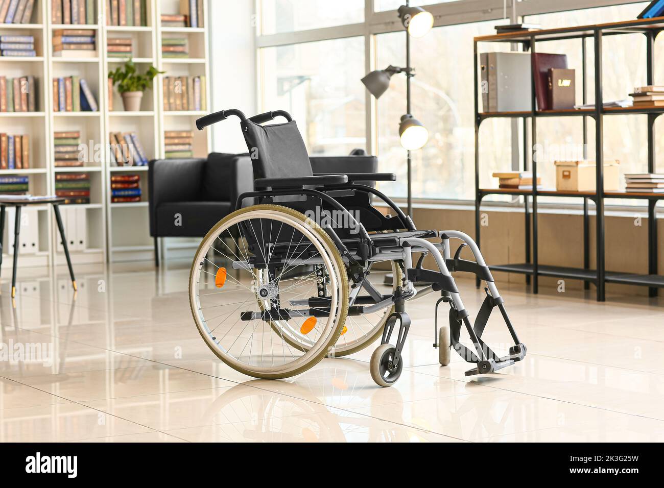 Modern wheelchair in home library Stock Photo - Alamy
