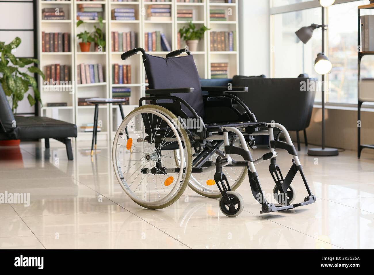 Modern wheelchair in home library Stock Photo - Alamy