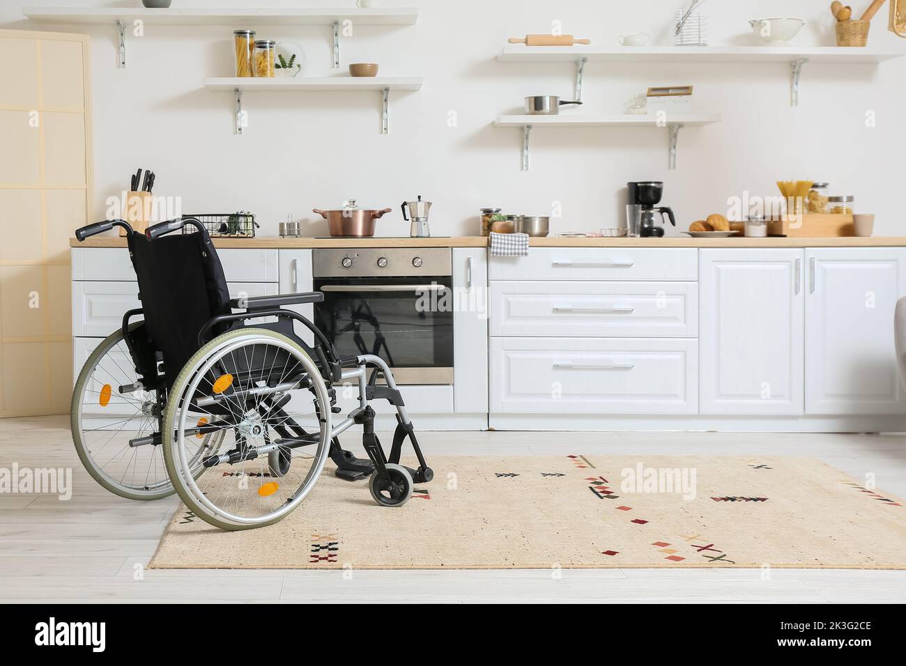 Modern empty wheelchair in kitchen Stock Photo - Alamy