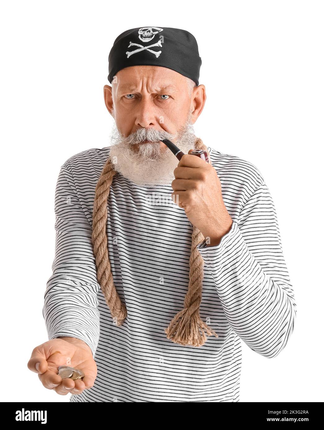 Mature bearded man dressed as pirate with smoking pipe, coins and rope ...