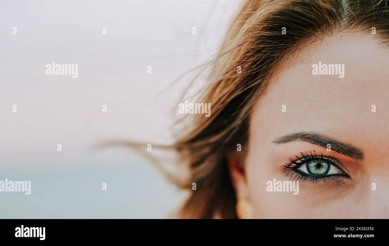 Copy space. Close up of woman green eye contracting. Female with ...