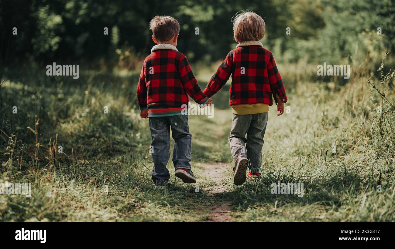 Cute kids walking together holding hands in autumn park. Smiling ...