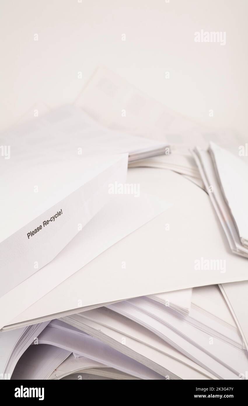 Please Re-cycle notice on top of pile of stapled white paper sheet ...