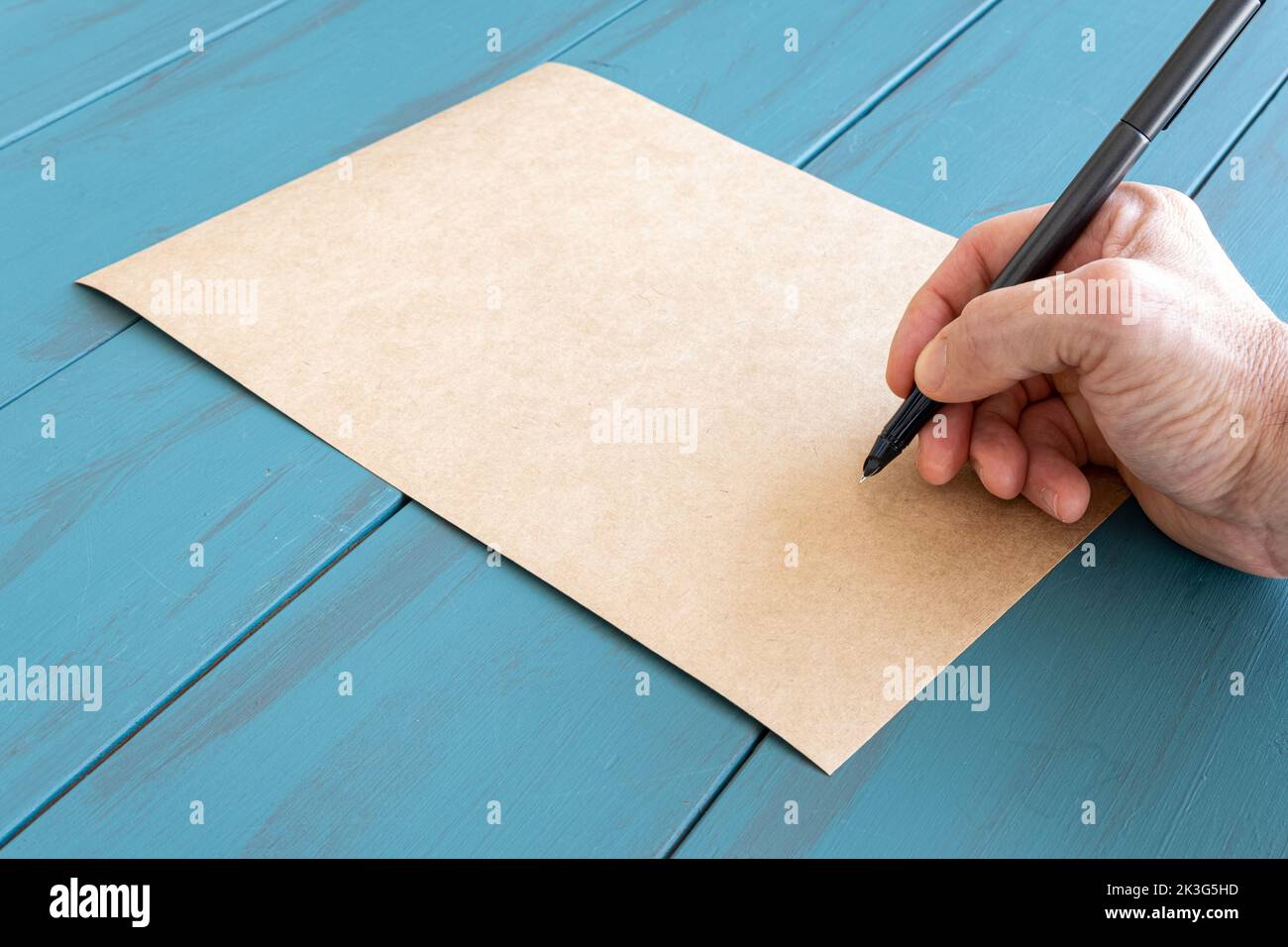 Man's hand with fountain pen, on a brown paper, ready to sign Stock ...