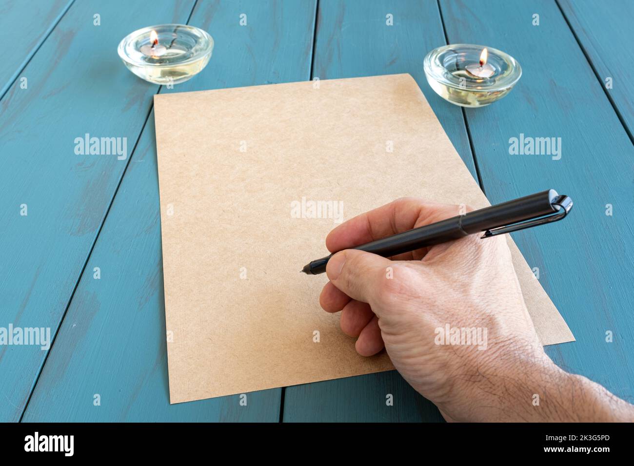 Closeup of man's hand with fountain pen over brown paper, ready to sign ...
