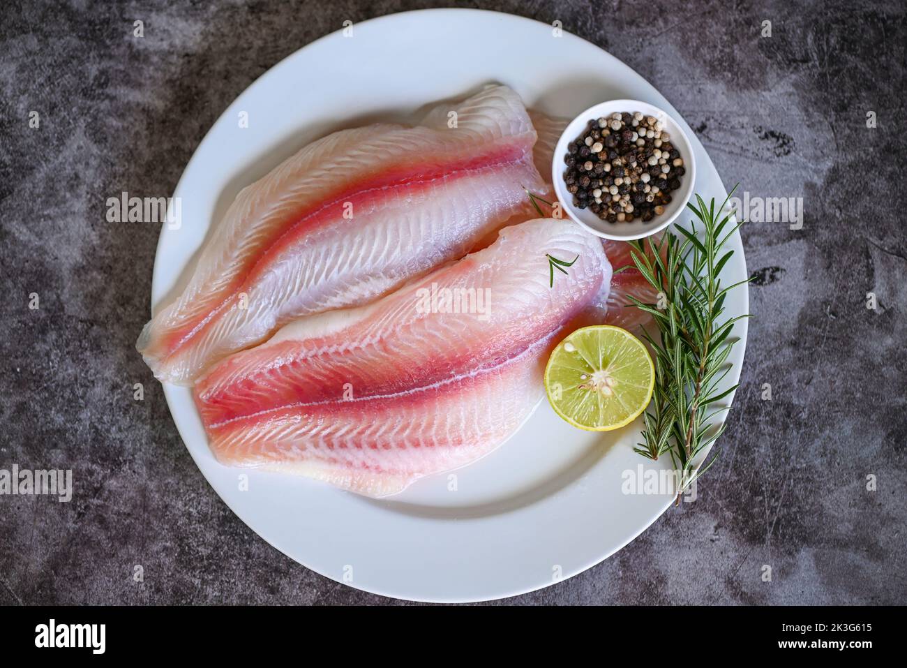 fresh raw pangasius fish fillet with herb and spices lemon lime and ...