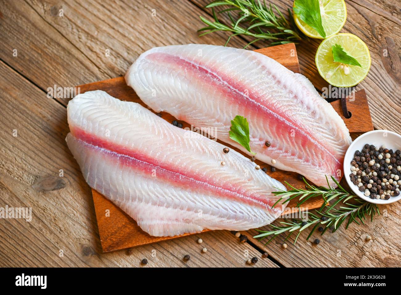 fish fillet on wooden board with ingredients for cooking, meat dolly ...