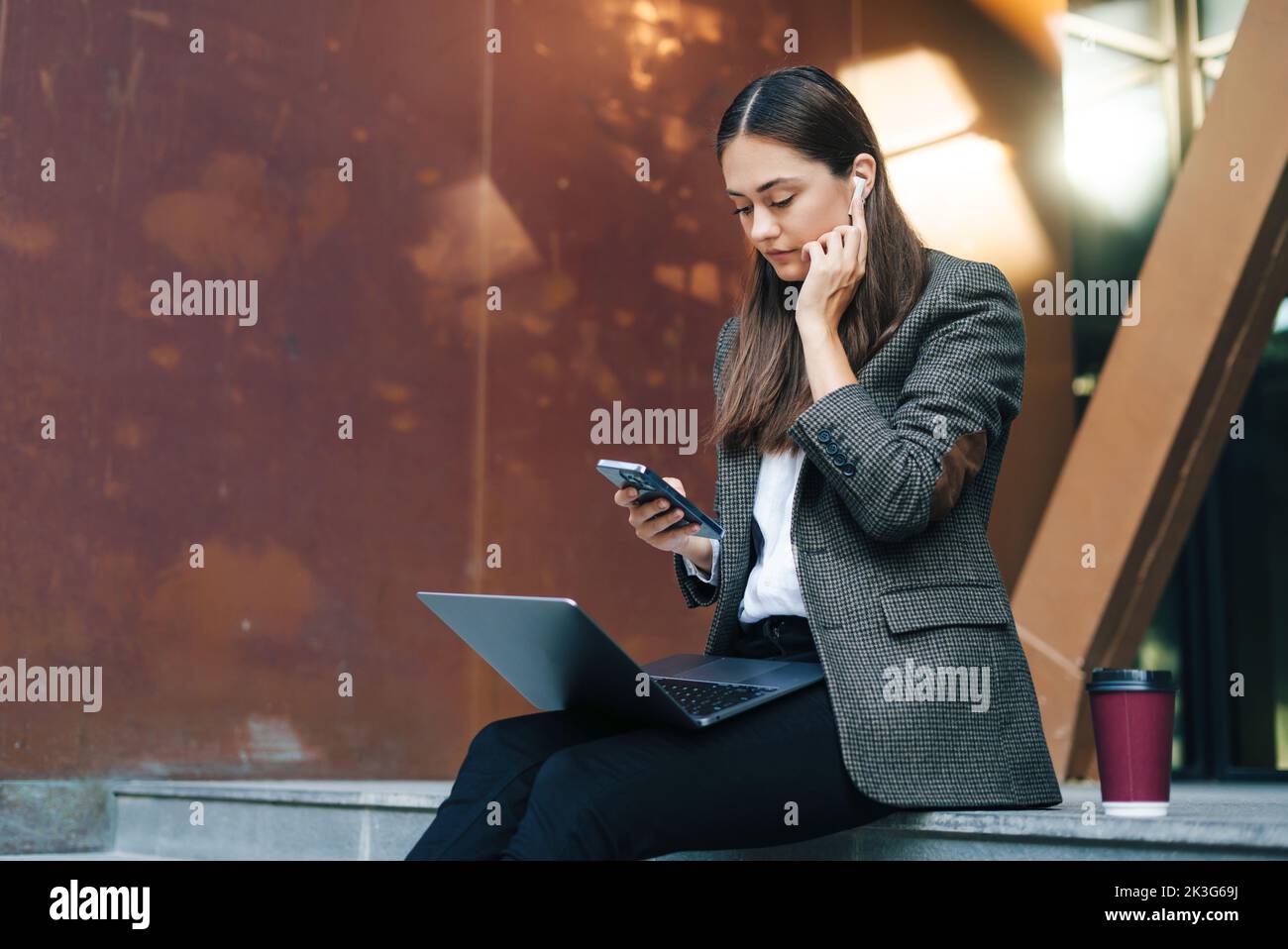 Long haired young woman working after shift hours with laptop and ...