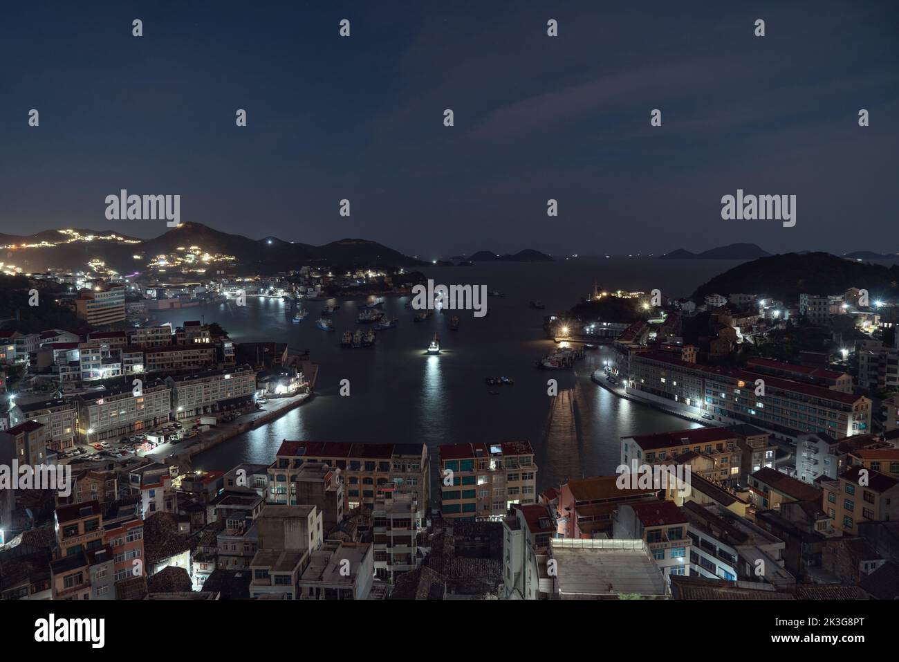 Seaside port with residental houses around at night, in Taizhou ...