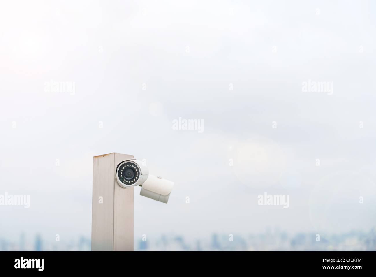 Modern CCTV camera against city and sky background. surveillance, video ...