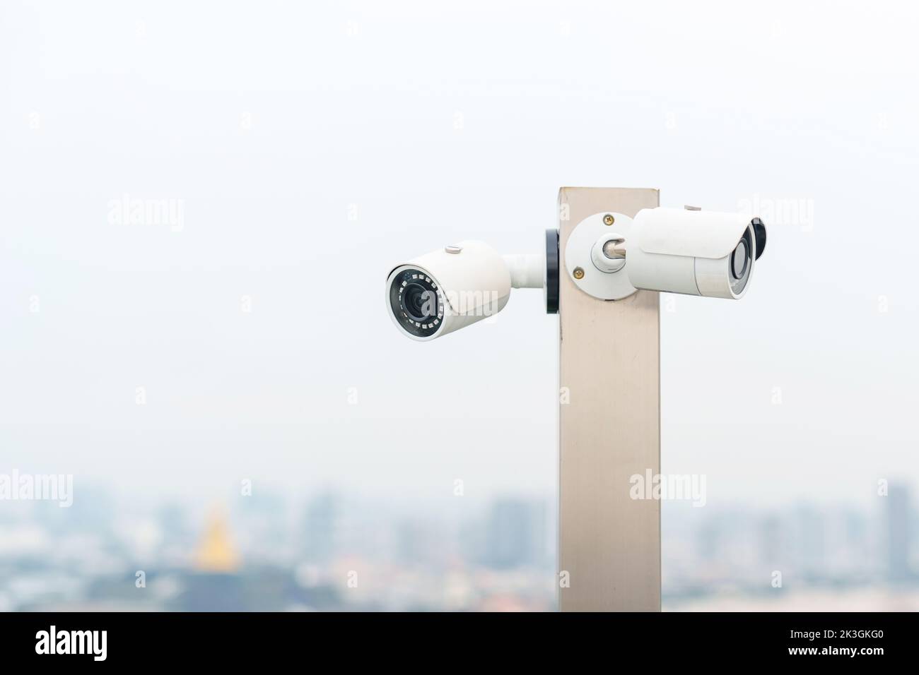 Modern CCTV camera against city and sky background. surveillance, video ...