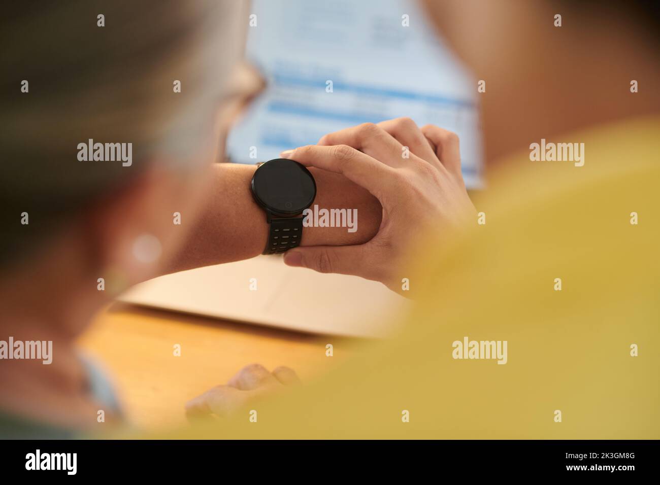 Closeup image of young man explaining grandmother how to use ...