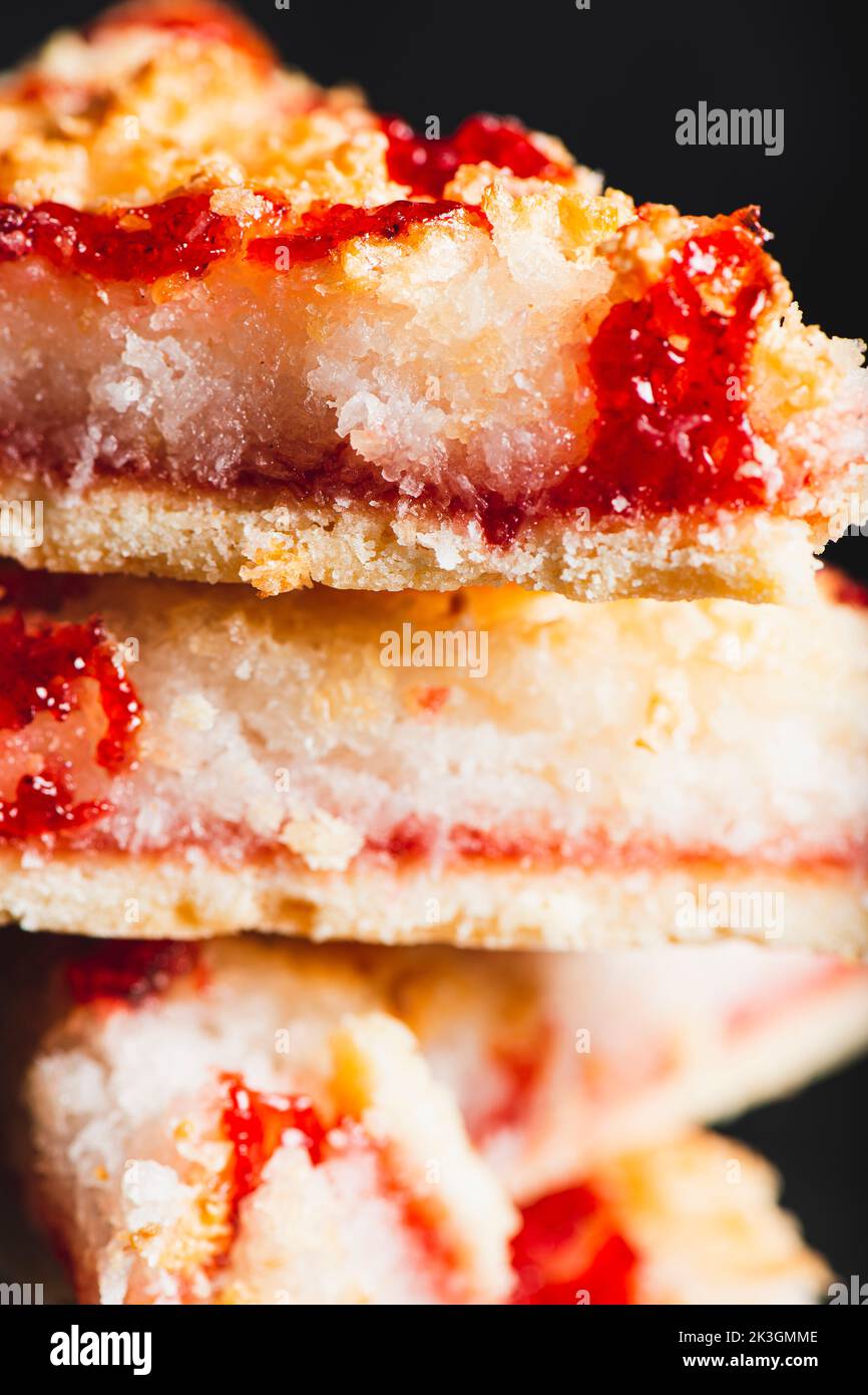 Freshly made coconut slice with rasplum jam Stock Photo - Alamy