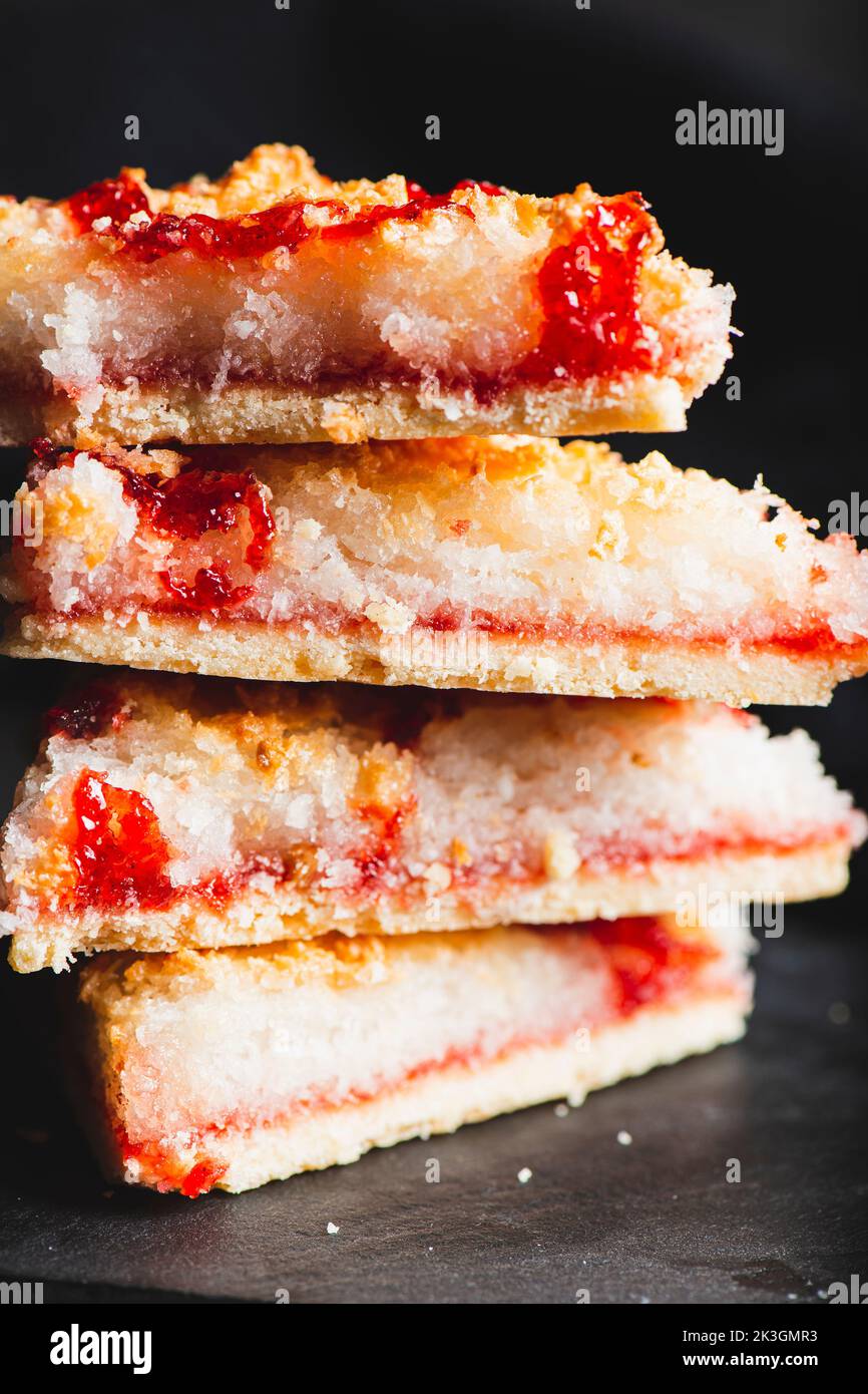 Freshly made coconut slice with rasplum jam Stock Photo - Alamy