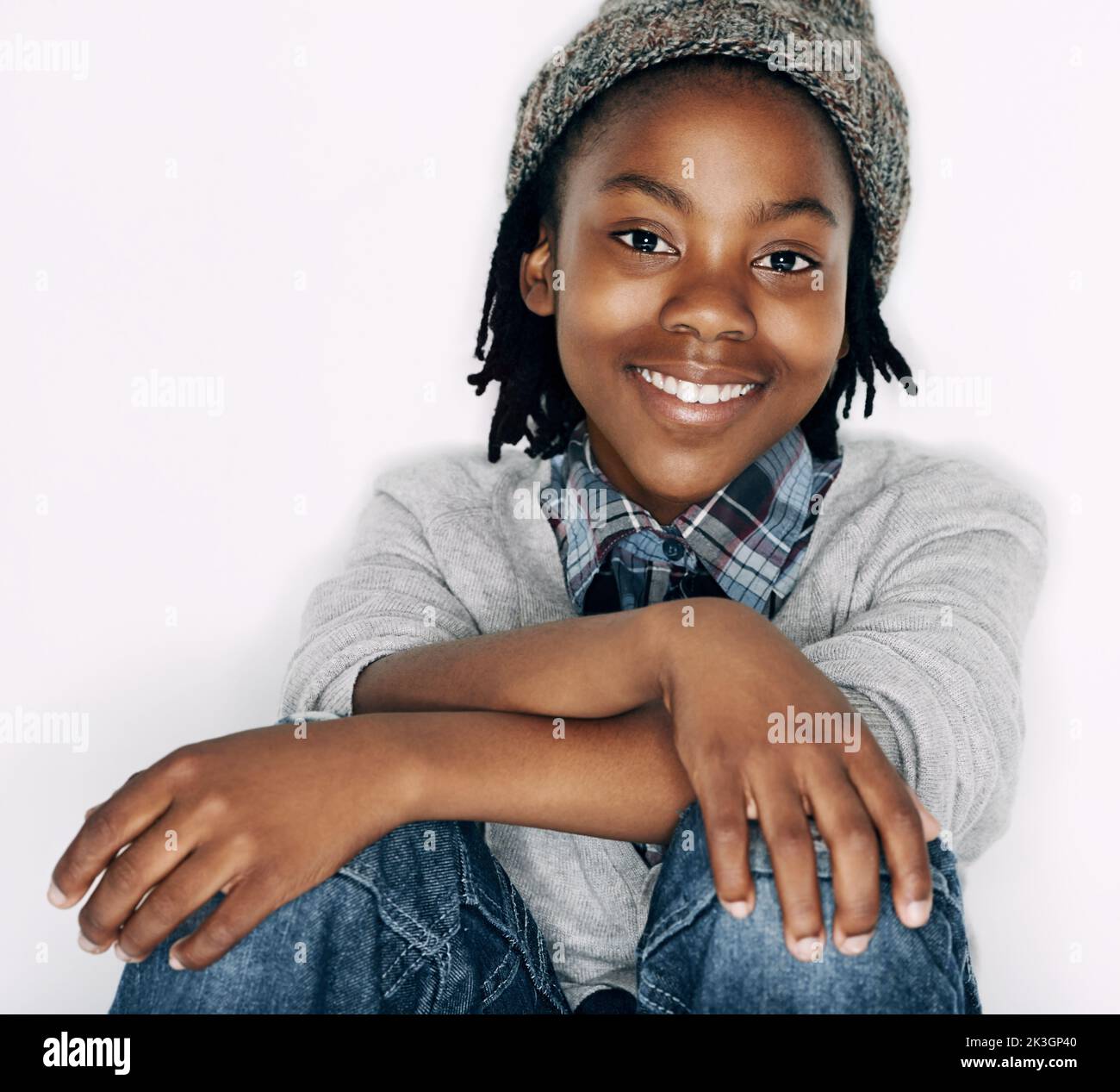 Hes a cool kid. Portrait of a young boy sitting in the studio Stock ...