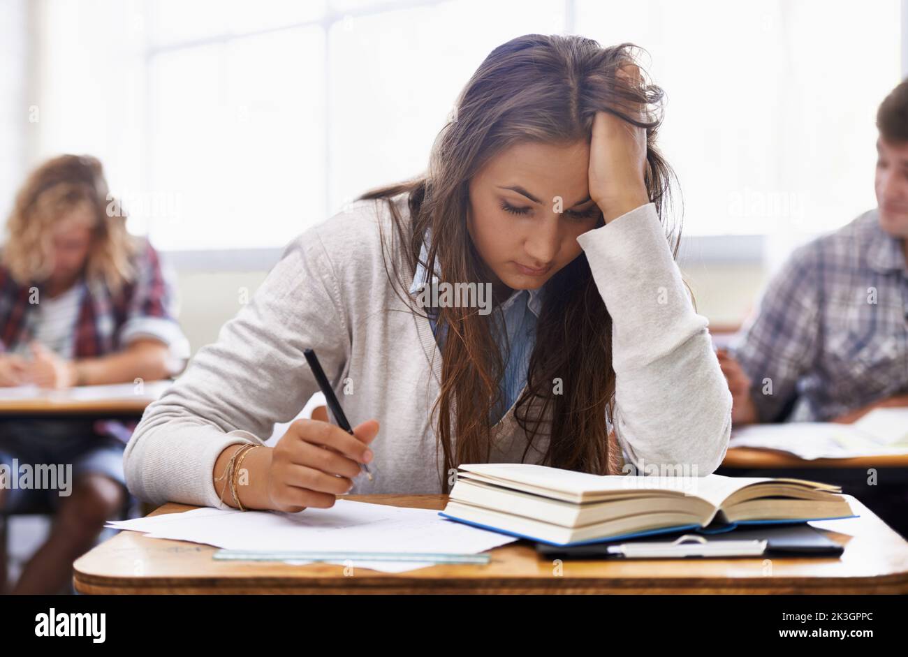 How will I handle this course load. An overworked young student sitting ...