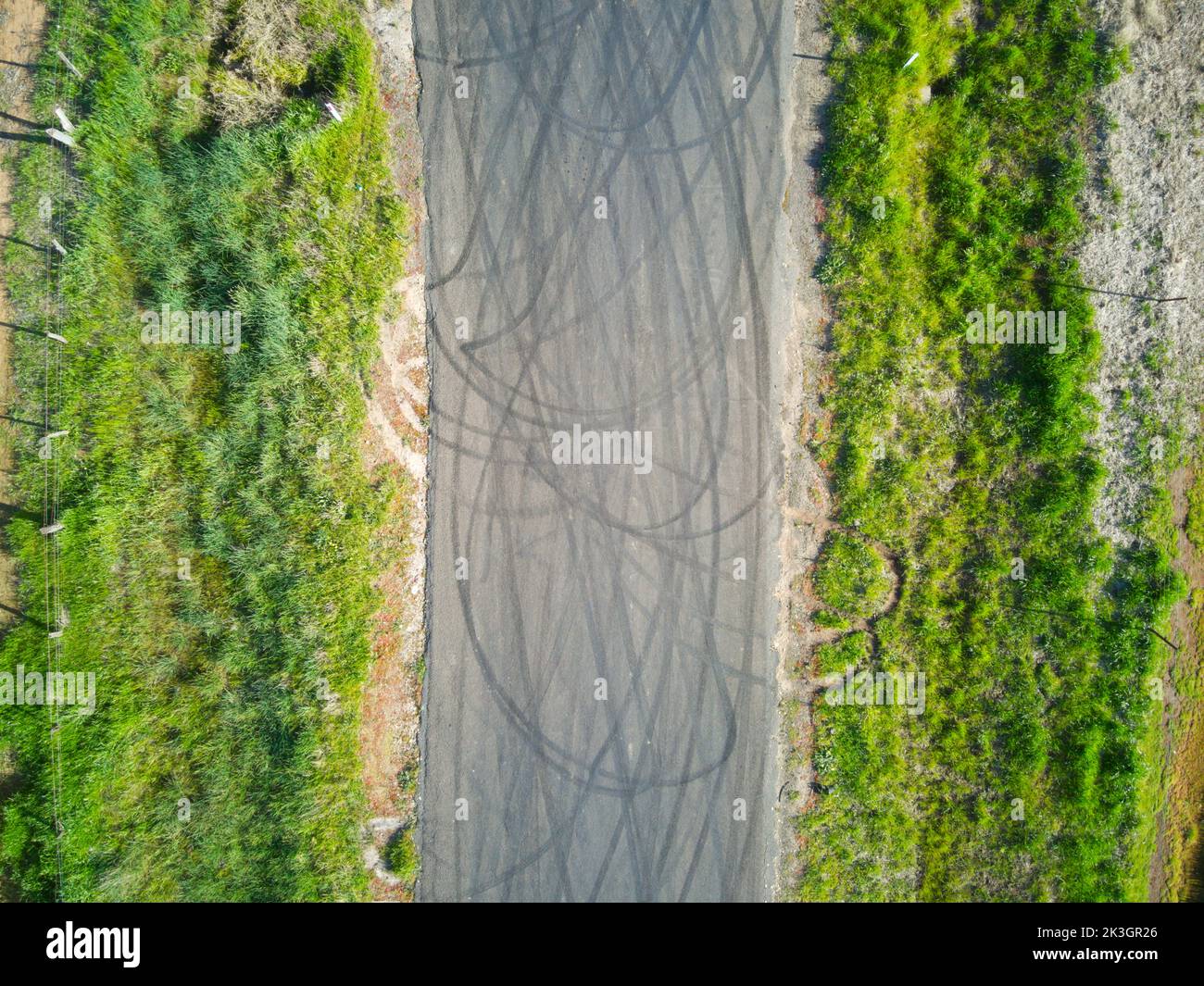 Skid mark aerial view showing rubber tyre patterns and green grass on ...