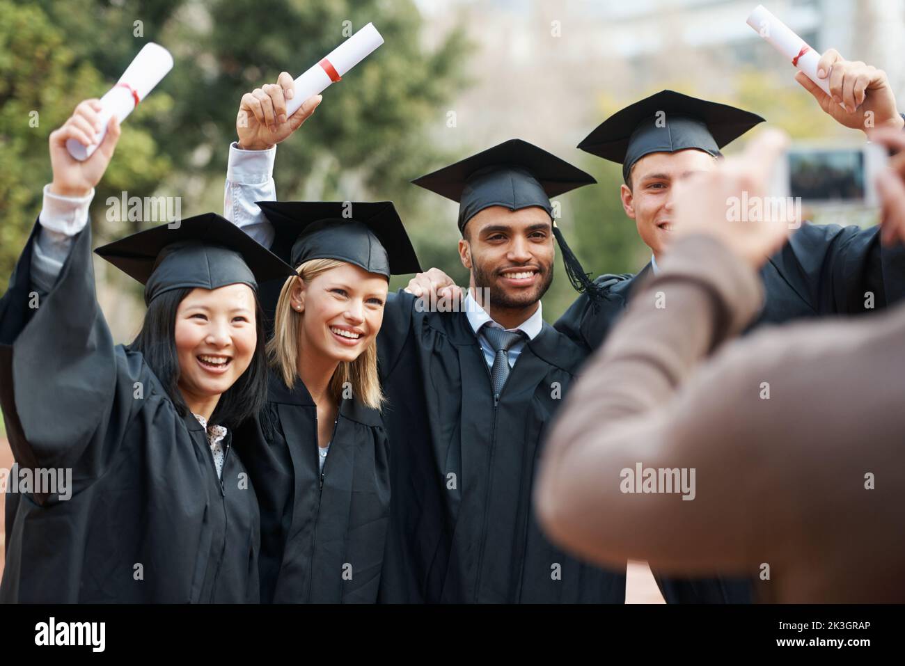 Say Ive graduated. A group of friends posing for a photograph in their ...