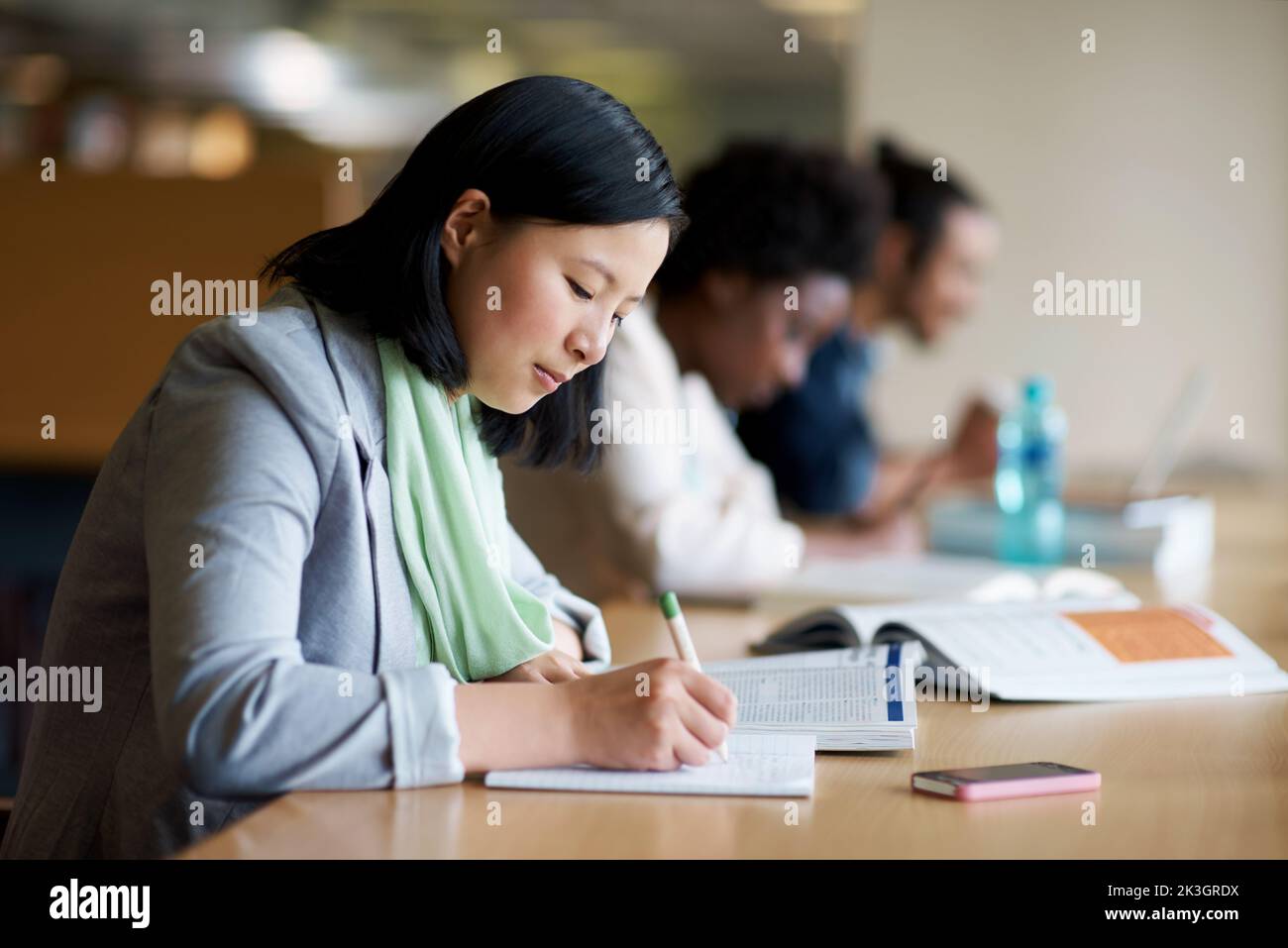 Cramming some last minute knowledge. A young woman studying in the ...