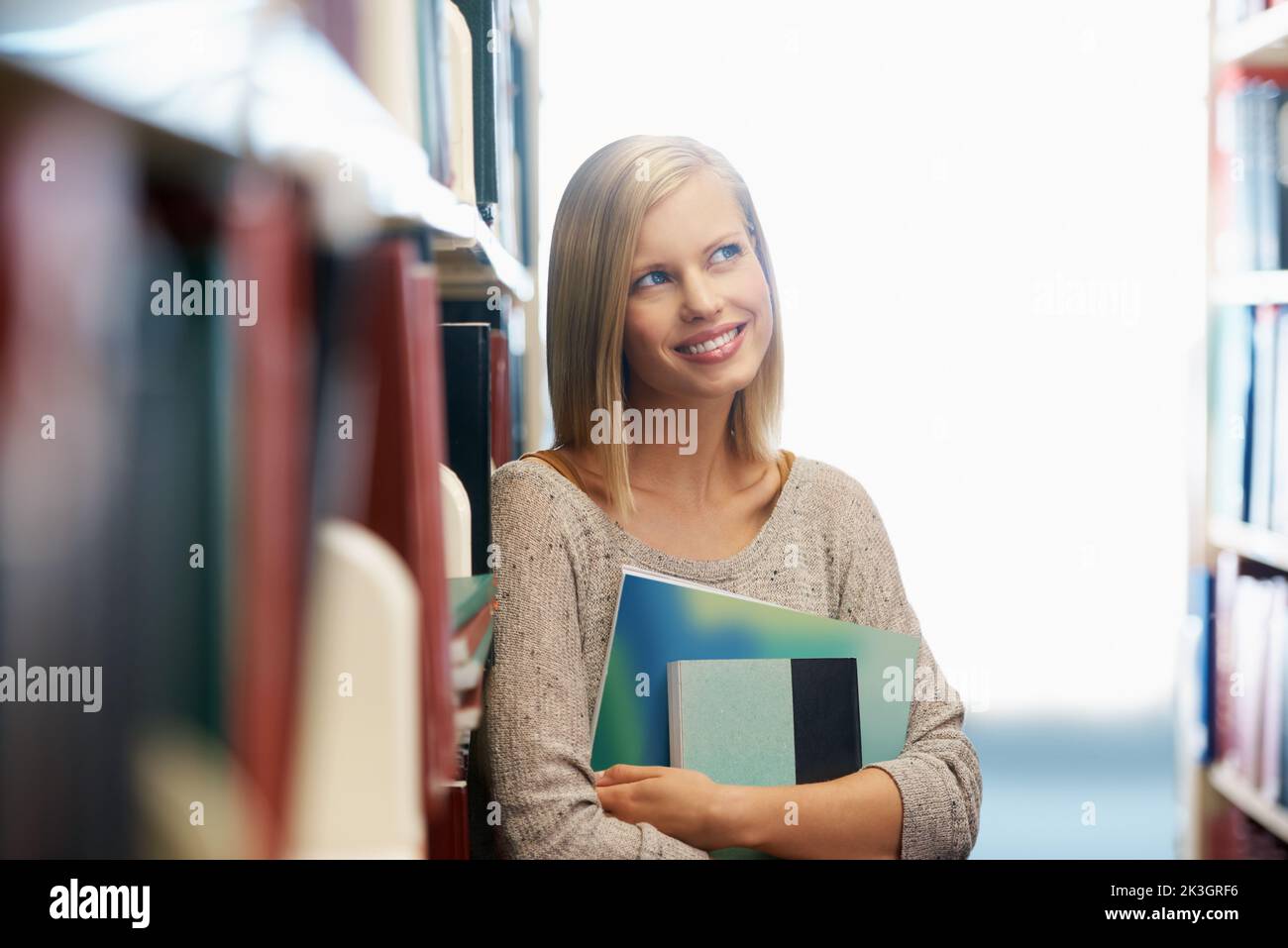 Woman holding books standing hi-res stock photography and images - Alamy
