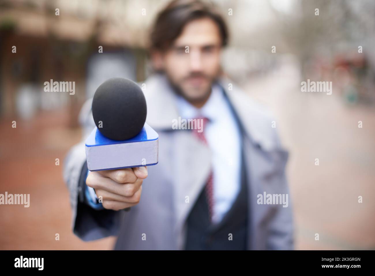Would you like to comment. Blurred shot of a reporter conducting an ...