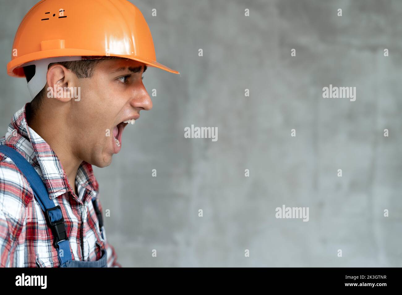 Young builder man wearing construction uniform and safety helmet over ...