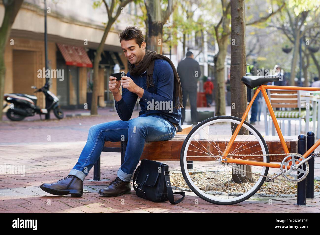 Taking a quick break. a handsome young bike-traveler Stock Photo - Alamy