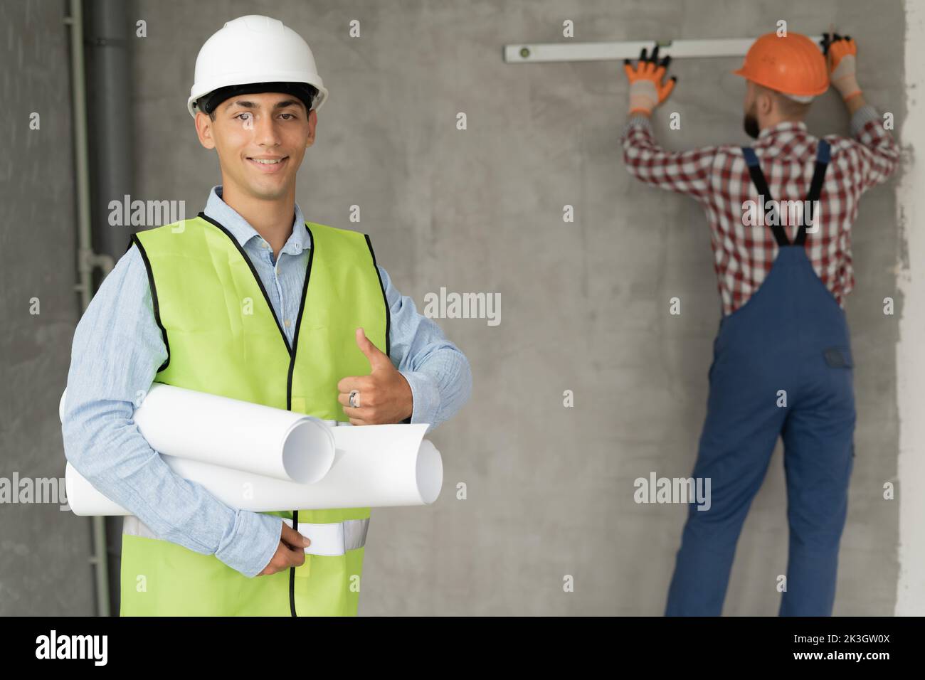 Home renovation concept. Happy engineer or architect showing a symbol ...