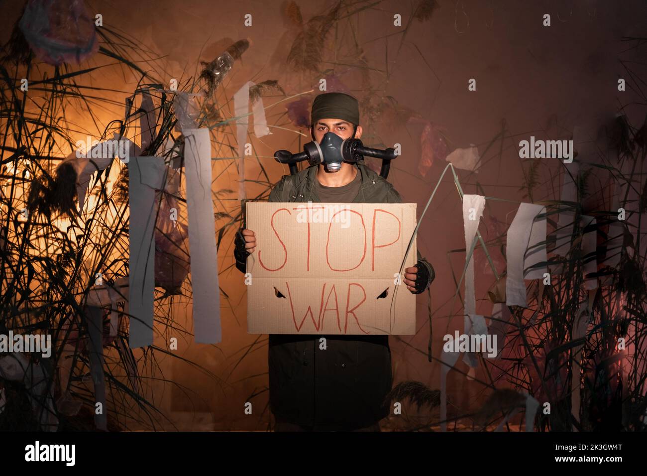 Environmental Protection. A man in a gas mask holds a poster with word ...