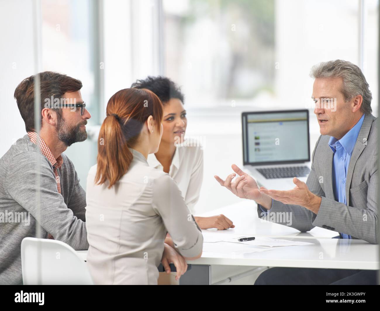 Teamwork gets business done. A group of businesspeople going over some ...