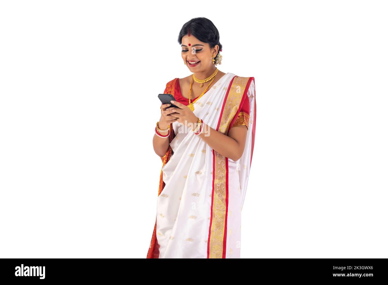 Young Bengali woman using mobile phone against white background Stock ...