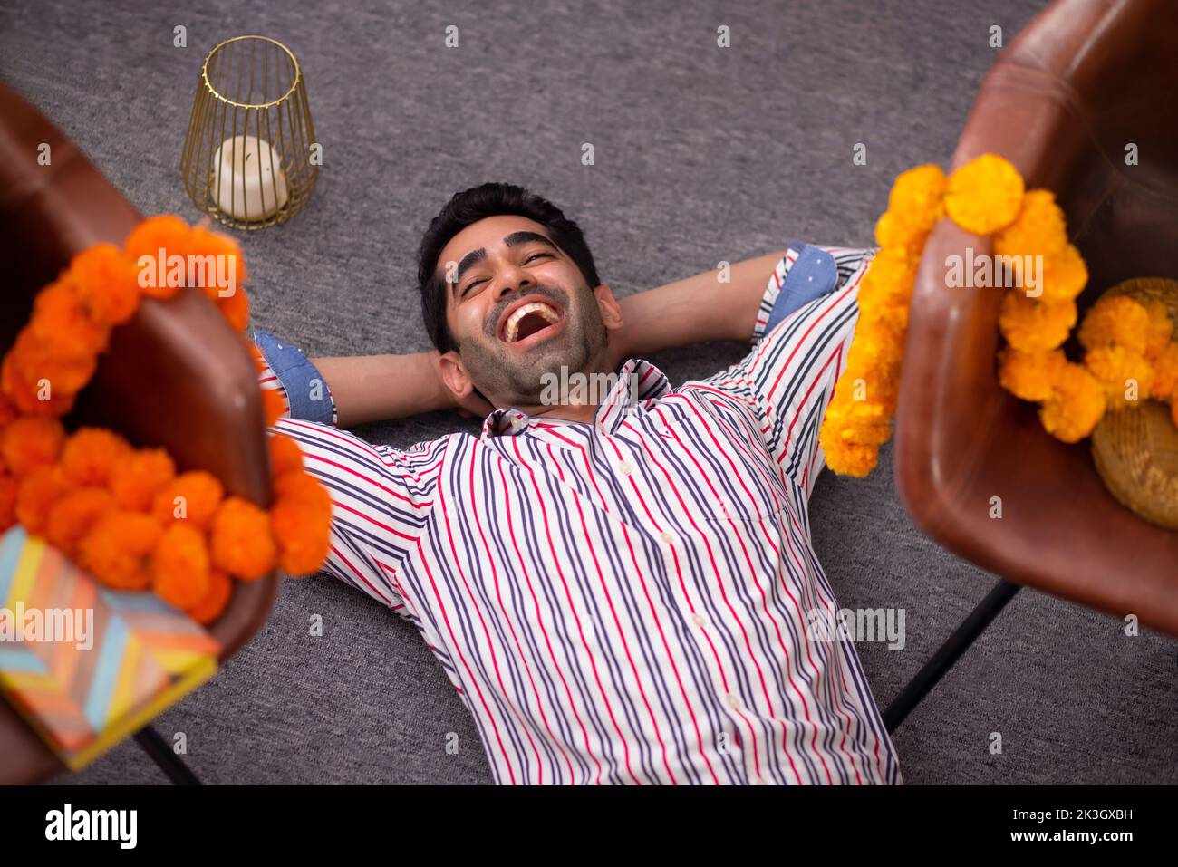 Top angle view of an employee lying on office floor during Diwali ...