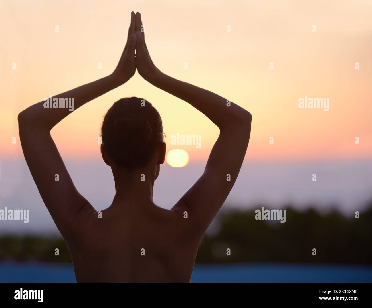 Finding tranquility in nature. A beautiful young woman in a yoga pose ...