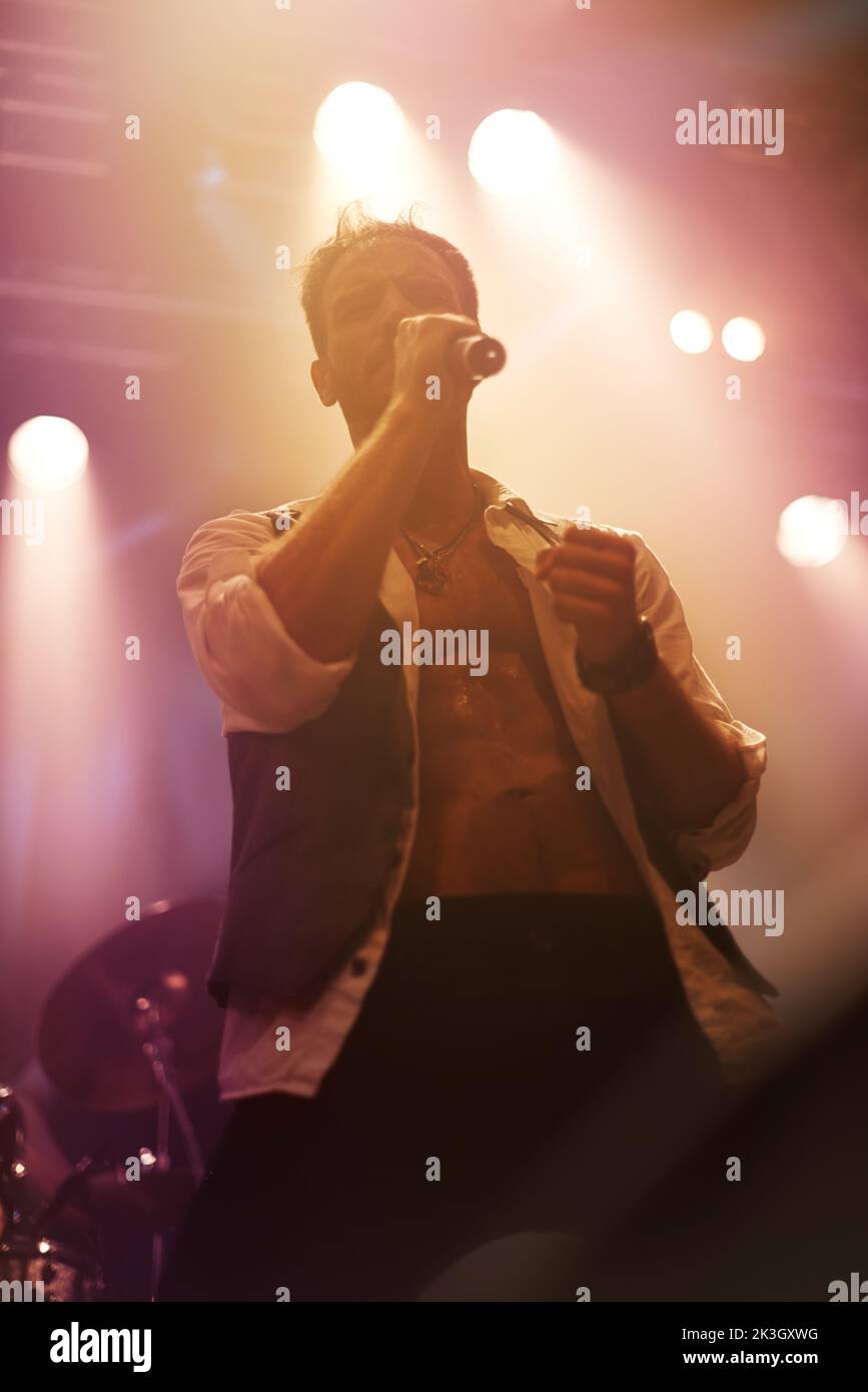 He calls the stage home. a performer on stage Stock Photo - Alamy