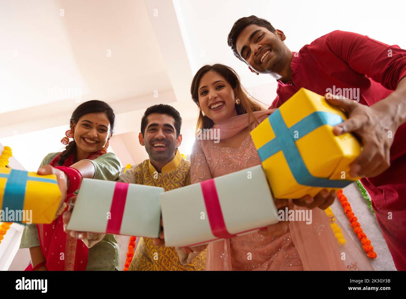 Colleagues standing together in office with gift boxes during Diwali celebration Stock Photo - Alamy