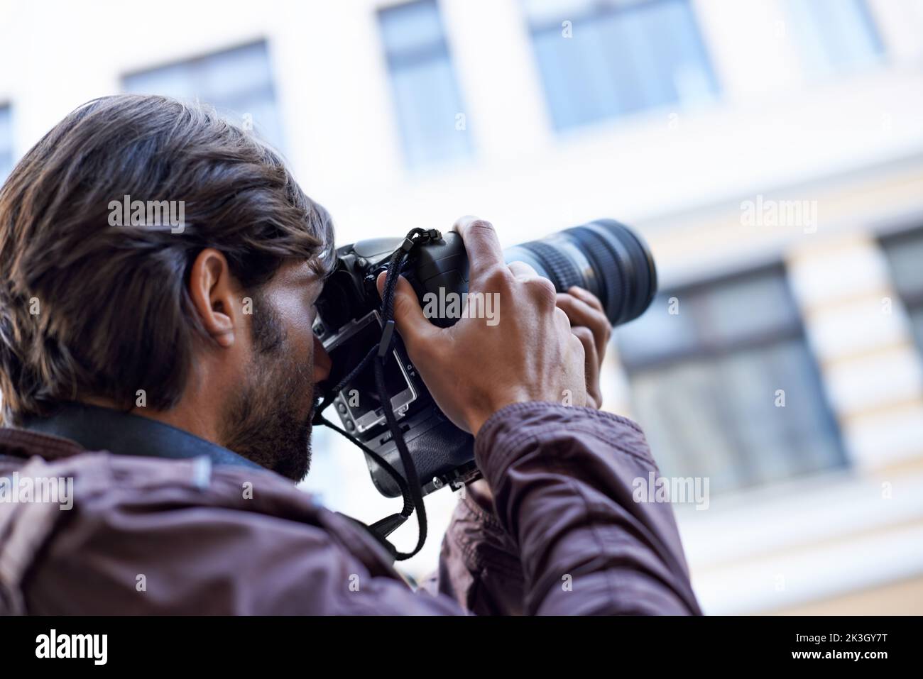 Capturing the beauty that surrounds him. A young man taking a picture ...