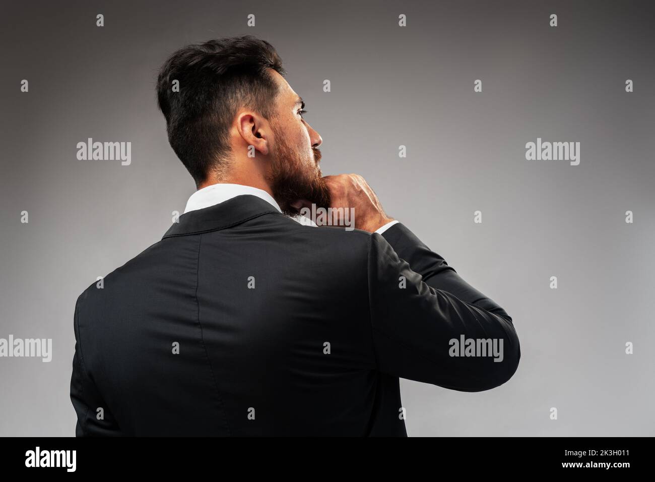 Studuo shot of thinking businessman standing over gray background Stock ...