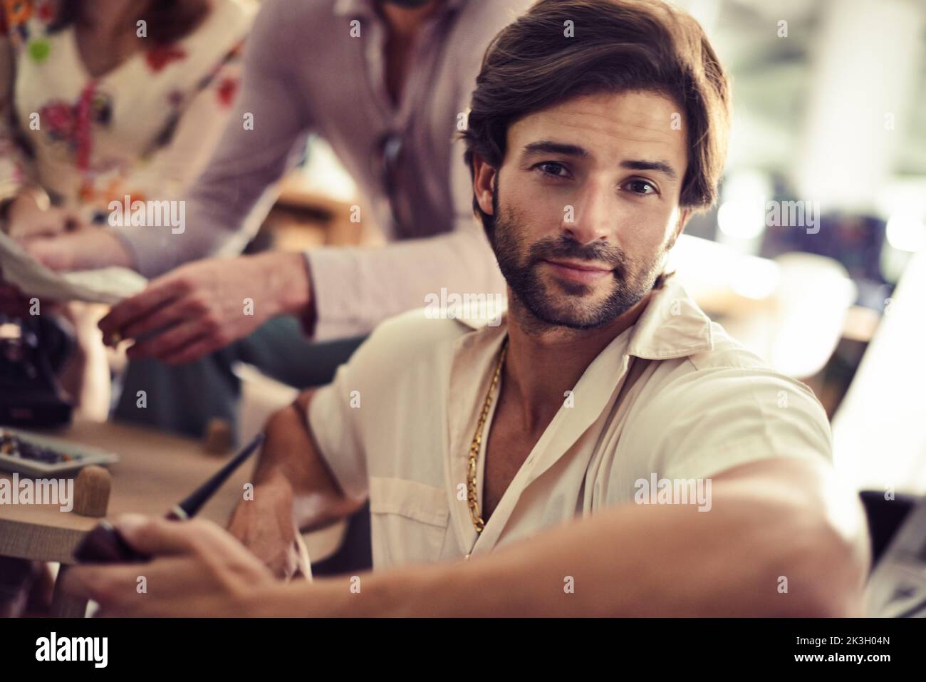 Retro revival. A group of people in retro attire sitting indoors having ...