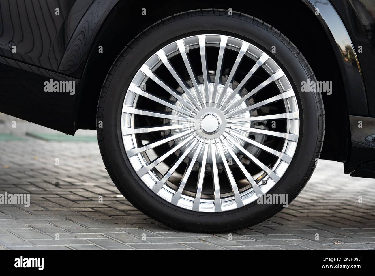 Aluminium rim of luxury black suv car wheel close up Stock Photo - Alamy