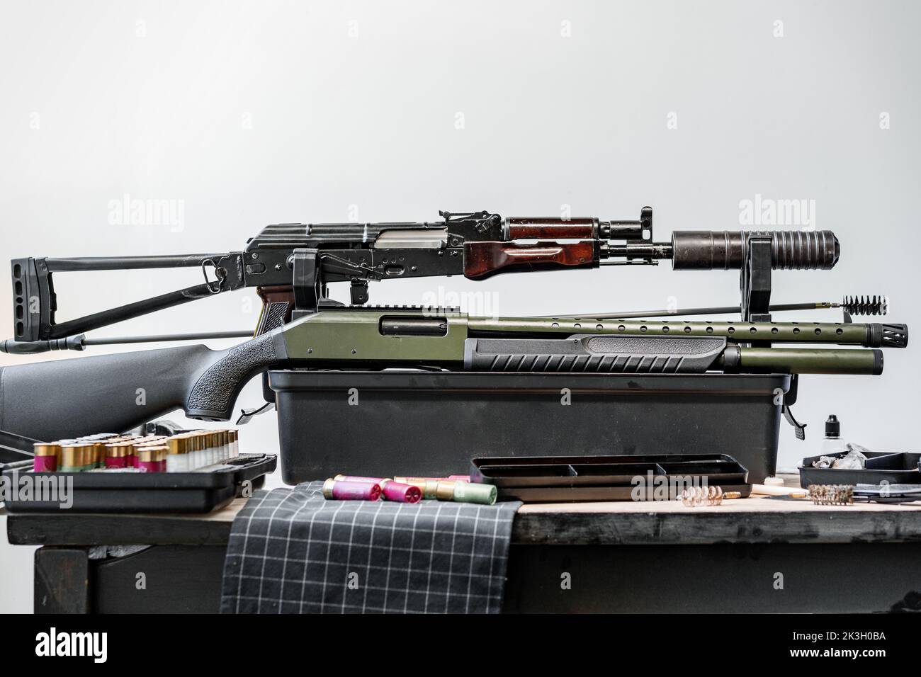 Shotgun rifle with cartridges on table in a weapon workshop Stock Photo ...