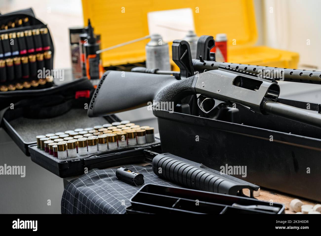 Shotgun rifle with cartridges on table in a weapon workshop Stock Photo ...