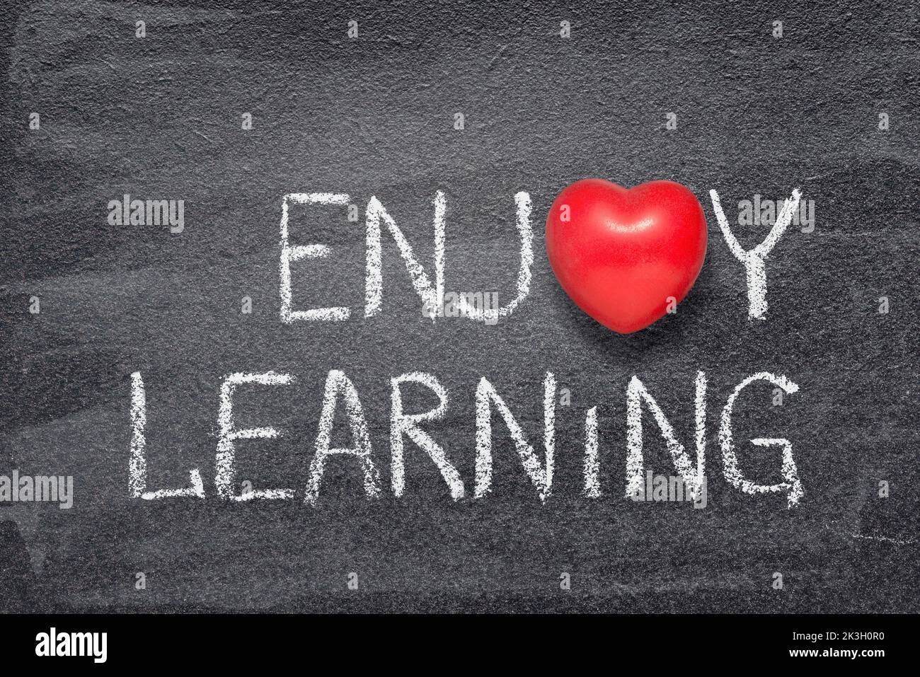enjoy learning phrase handwritten on chalkboard with red heart symbol ...