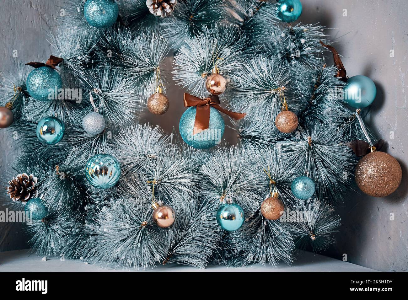 Christmas light blue wreath on a concrete wall background Stock Photo ...