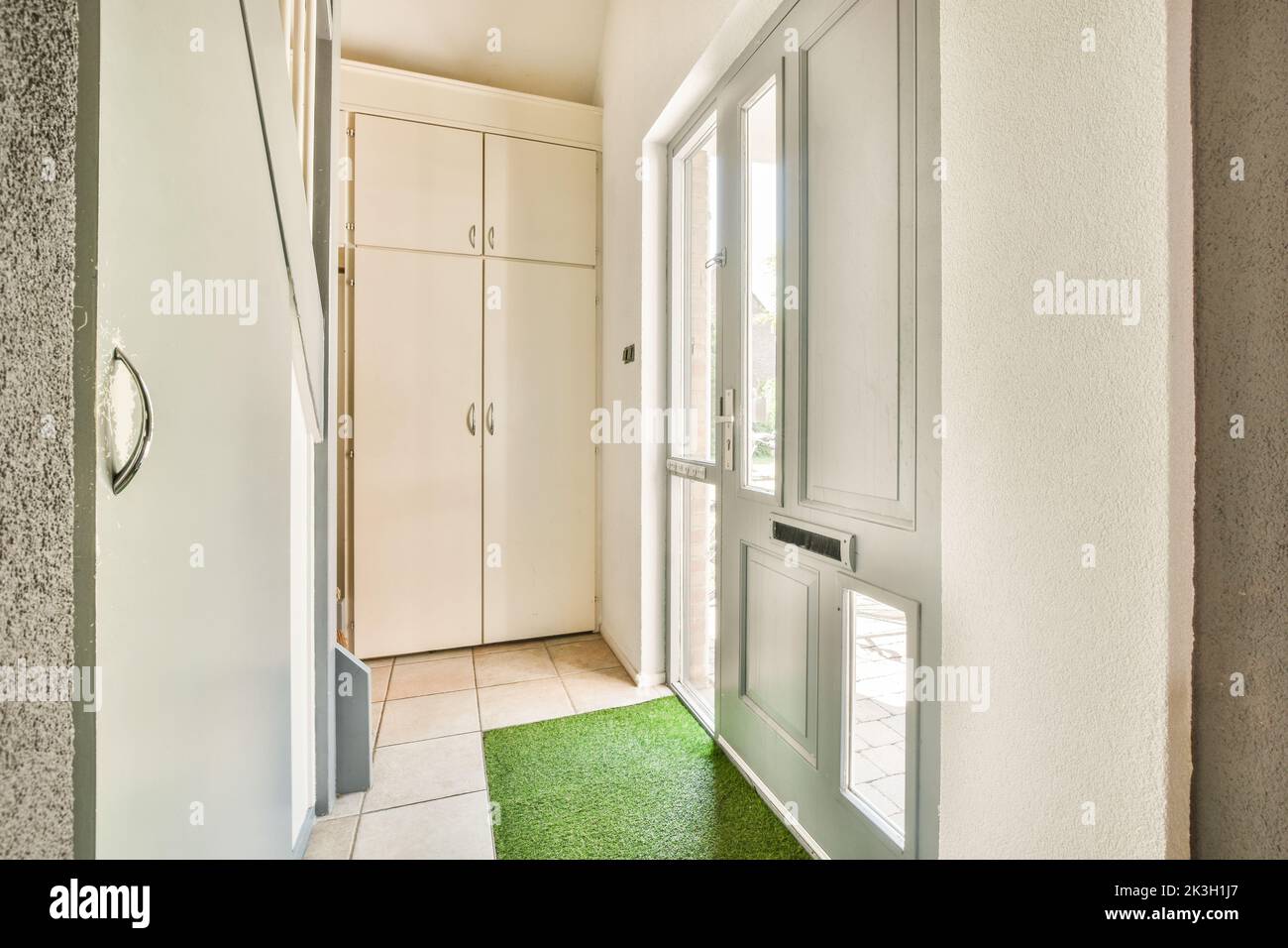 Light narrow hallway with many doors in white walls and glowing lamp ...