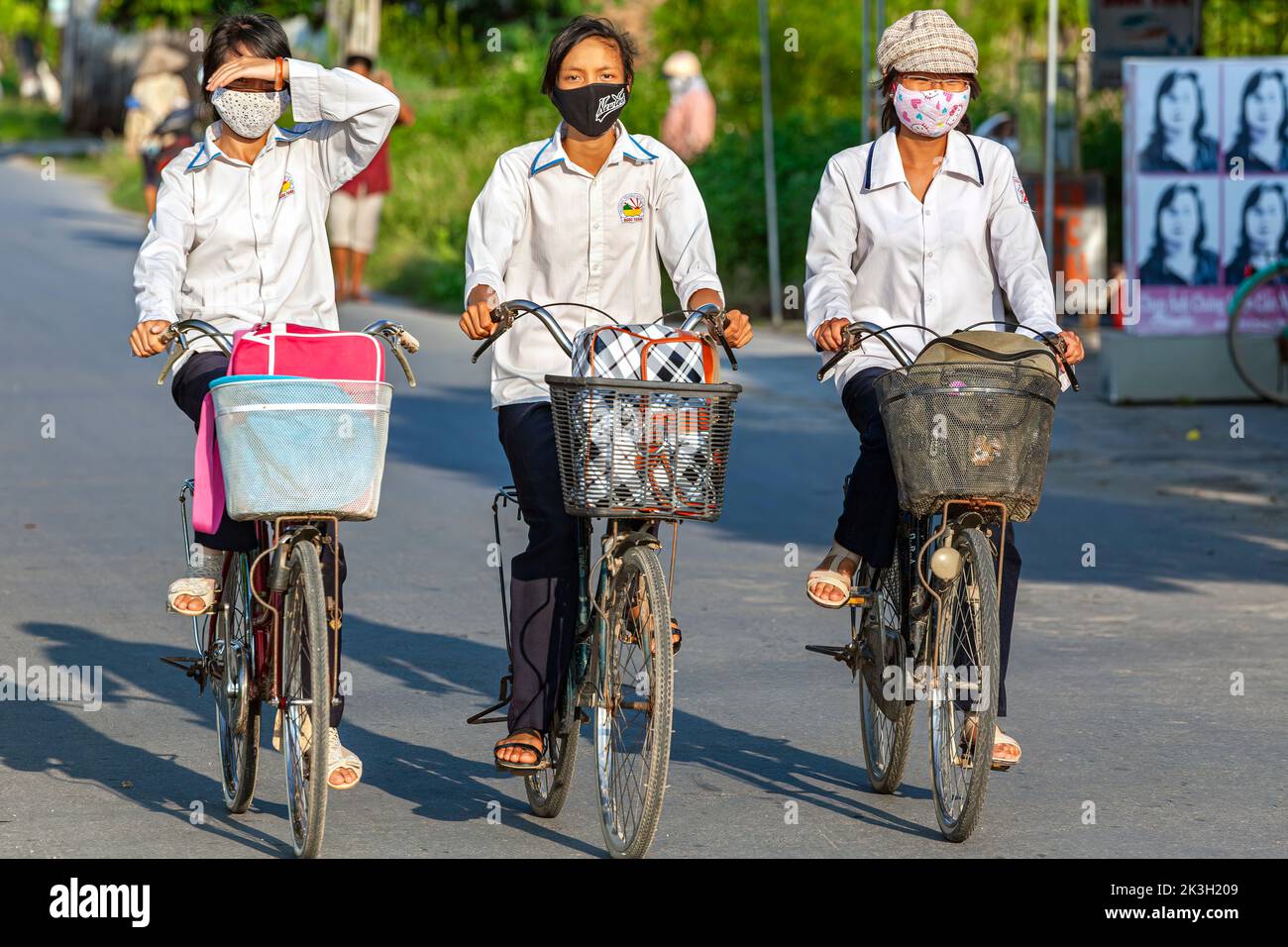 Vietnamese students riding bicycles on rural road, Hai Phong, Vietnam ...